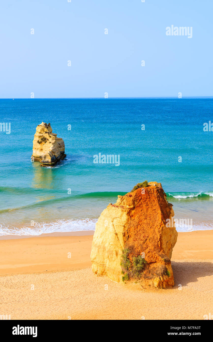 Rocks on beautiful sandy Praia da Rocha beach in Portimao town, Algarve ...