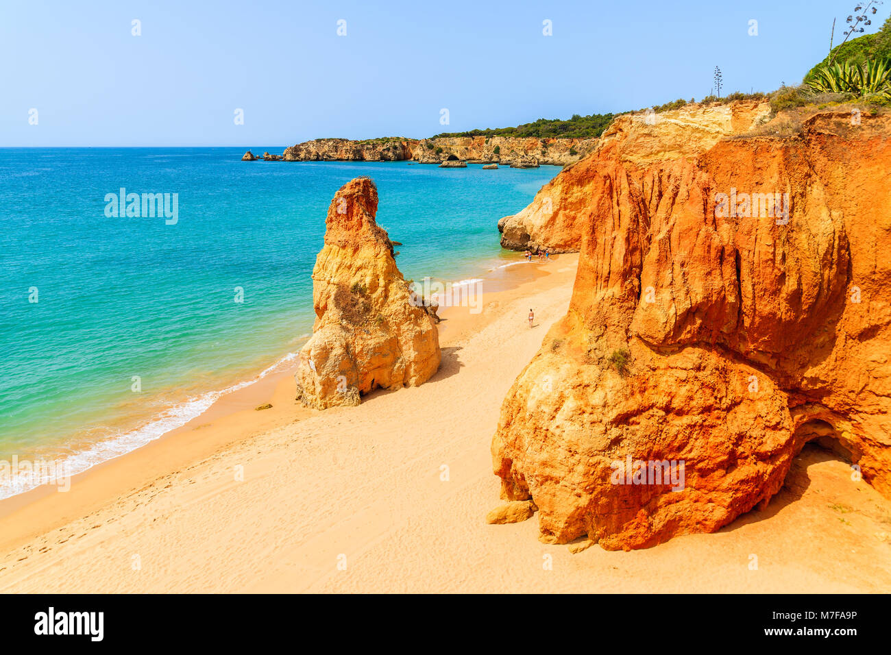 Sandy Praia da Rocha beach with golden color rocks in Portimao town ...