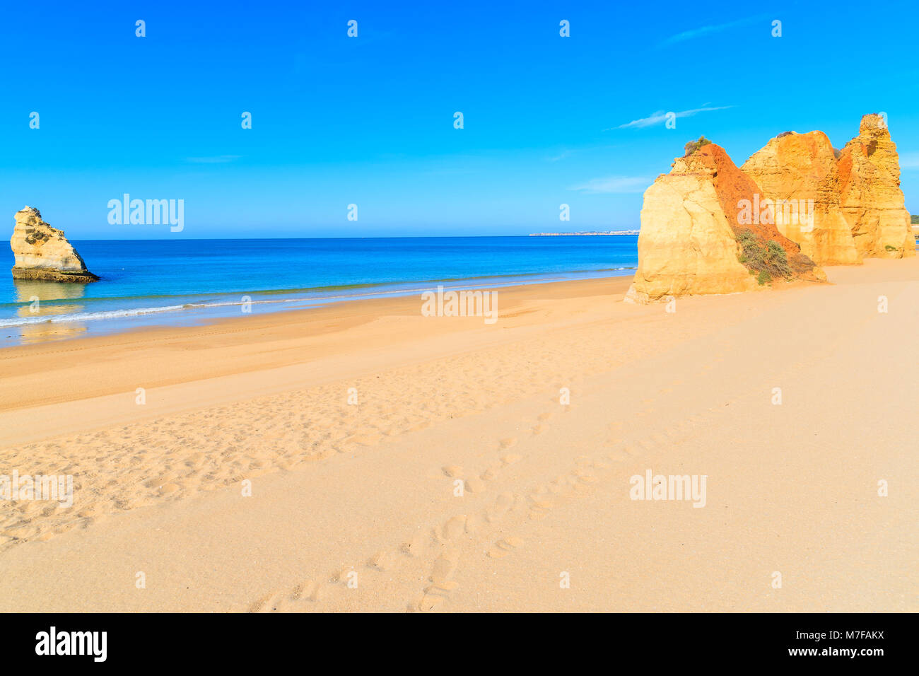 Rocks on beautiful sandy Praia da Rocha beach in Portimao town, Algarve ...