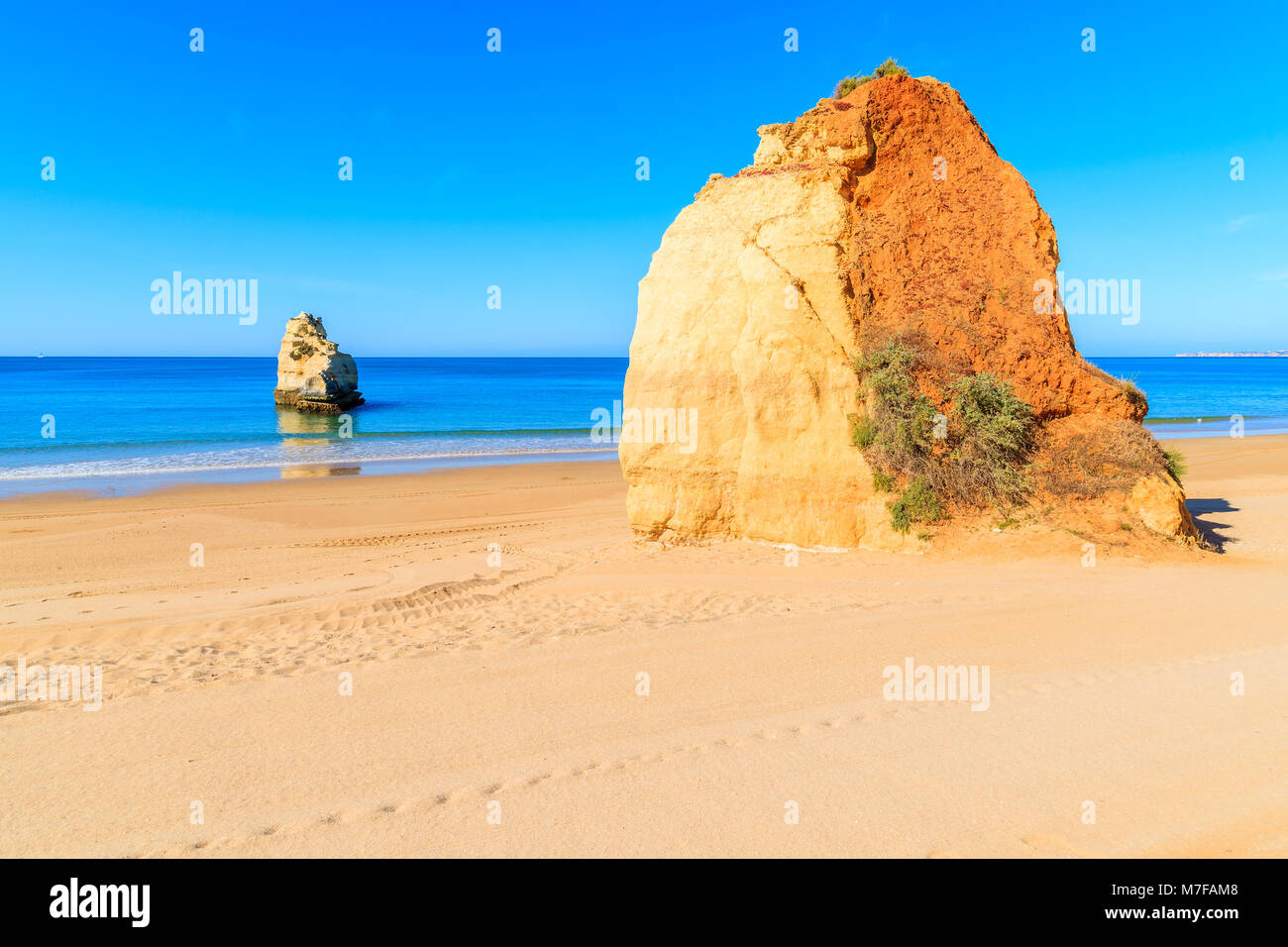 Rocks on beautiful sandy Praia da Rocha beach in Portimao town, Algarve ...