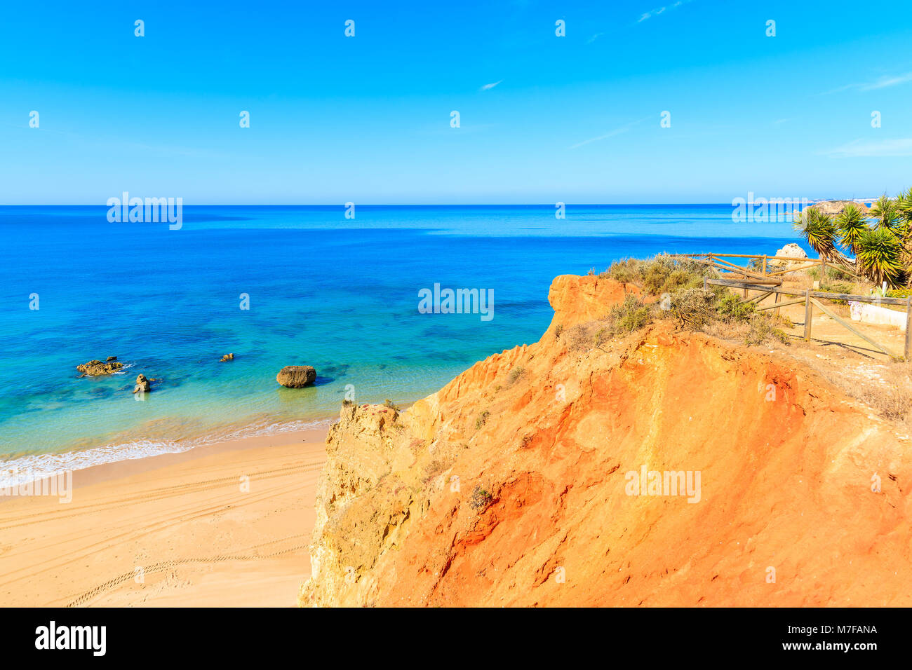 Rocks on beautiful sandy Praia da Rocha beach in Portimao town, Algarve ...