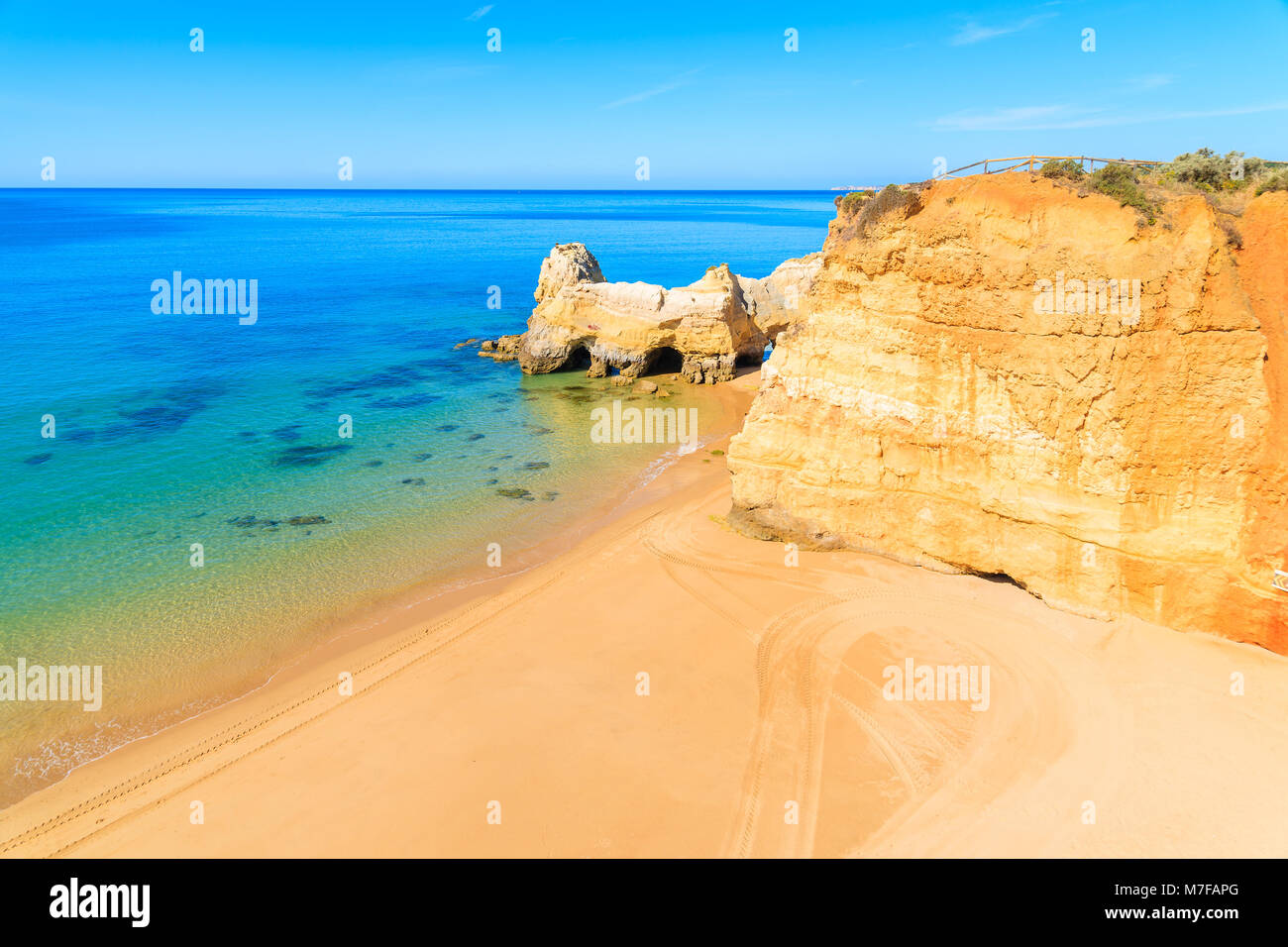 Rocks on beautiful sandy Praia da Rocha beach in Portimao town, Algarve ...