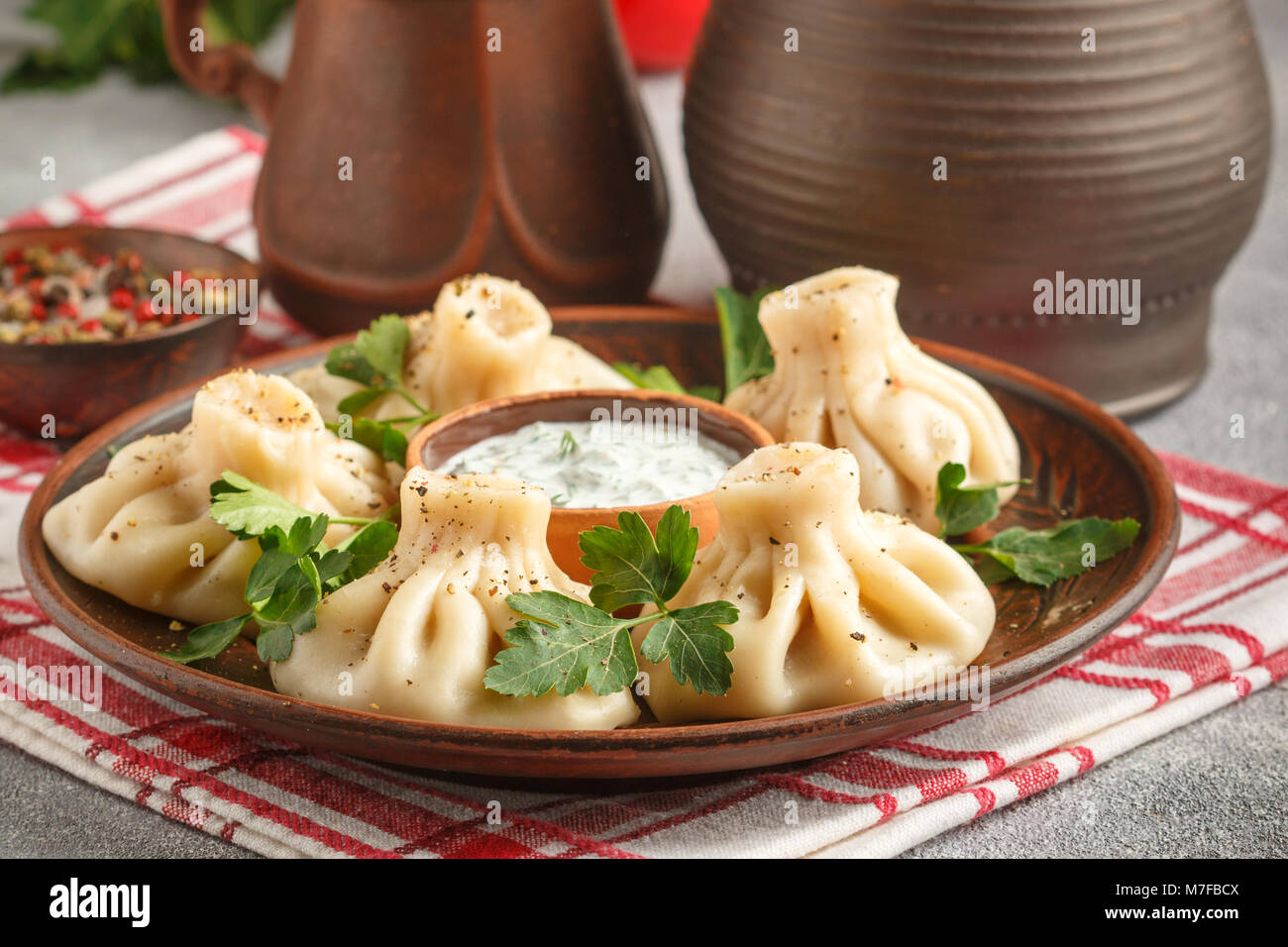 Khinkali - Georgian dumplings with meat and parsley in a ceramic dish ...