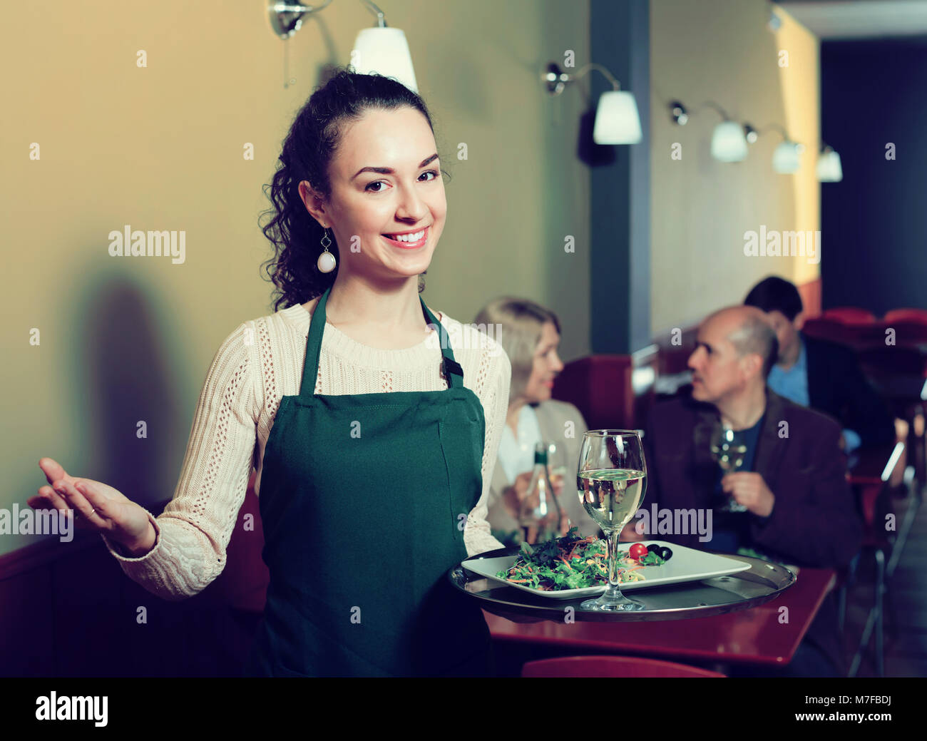 Portrait of young smiling waitress working in ordinary restaurant and ...