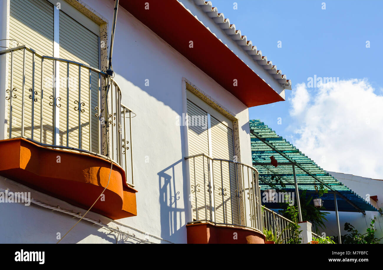 Stylish balcony with a metal railing, solid architectural element, a ...