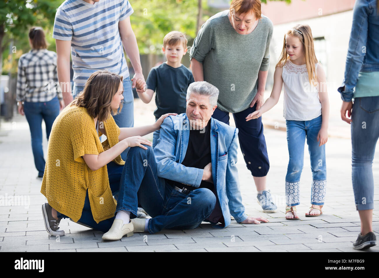 People of different ages helping grandfather with pain in heart Stock ...