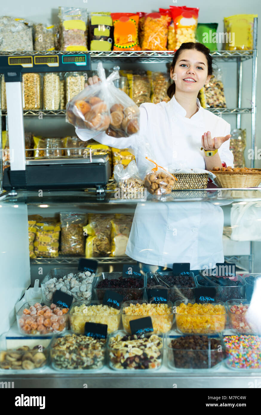 Female merchant is selling cupcakes in the shop Stock Photo - Alamy