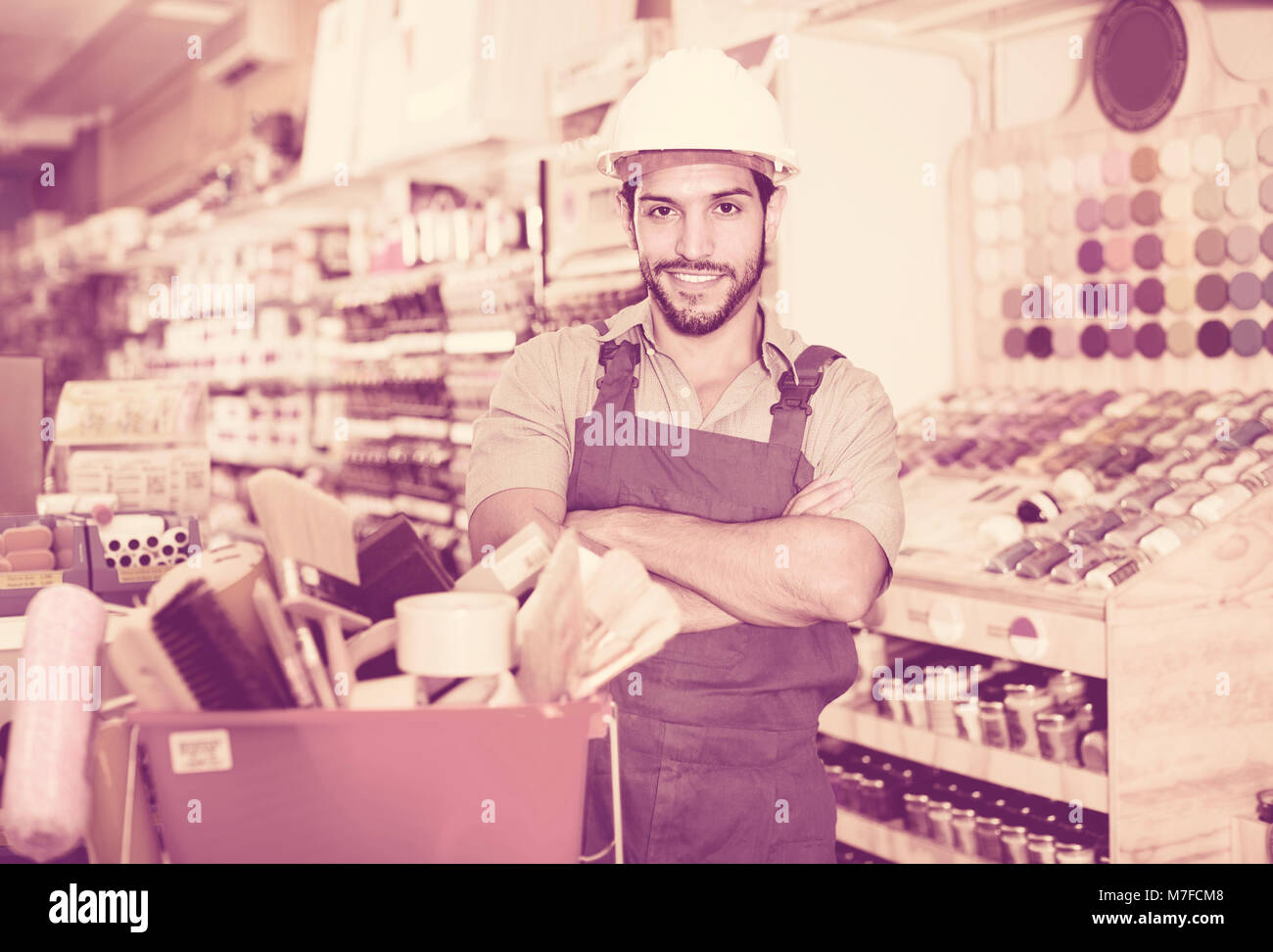 Happy cheerful positive smiling workman standing folded arms near ...