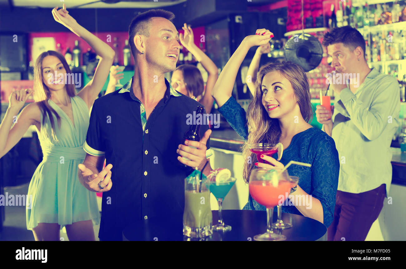Young happy students dancing on party with cocktails at a club Stock ...
