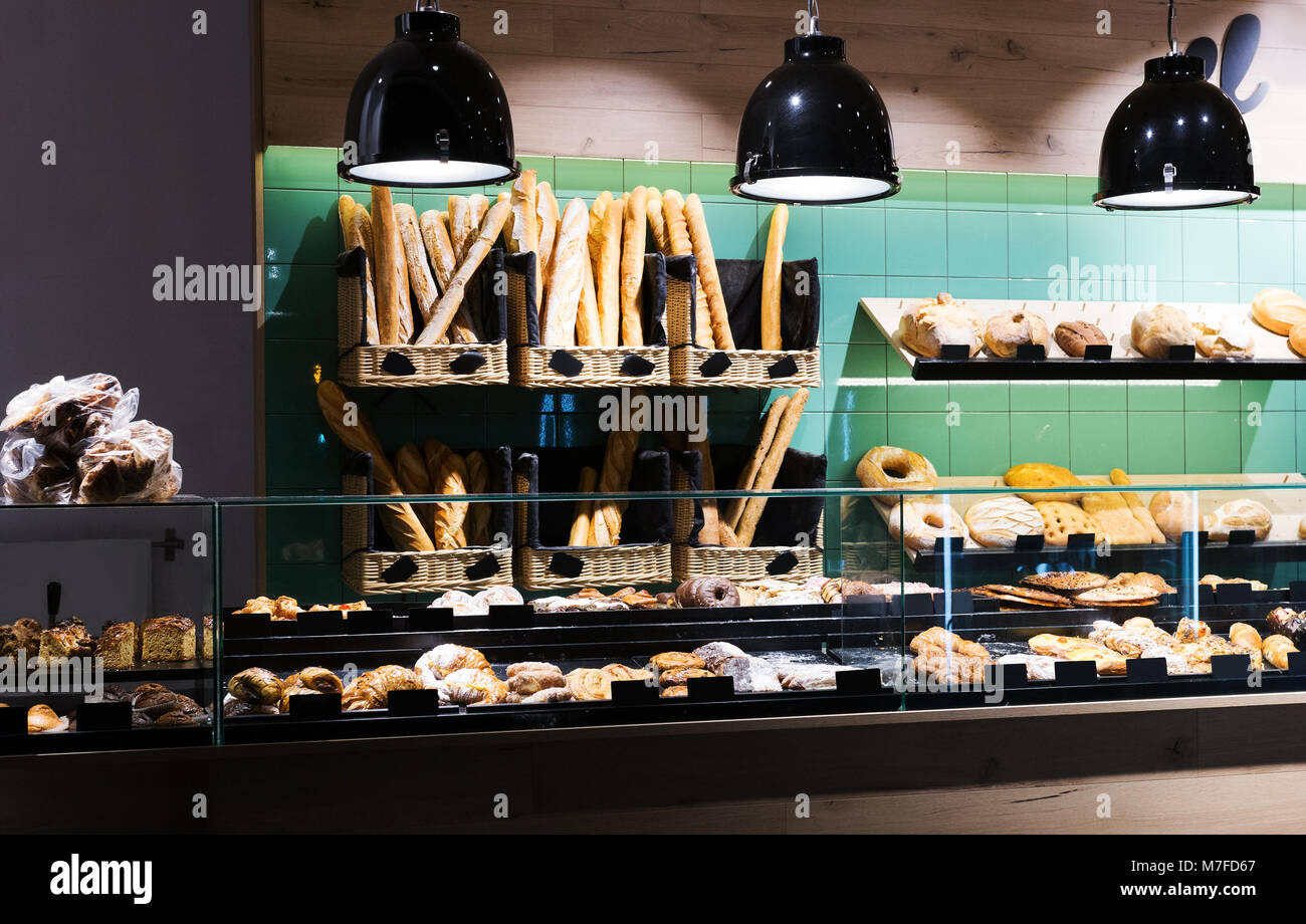 view on bakery counter with many different pastries and bread displayed ...