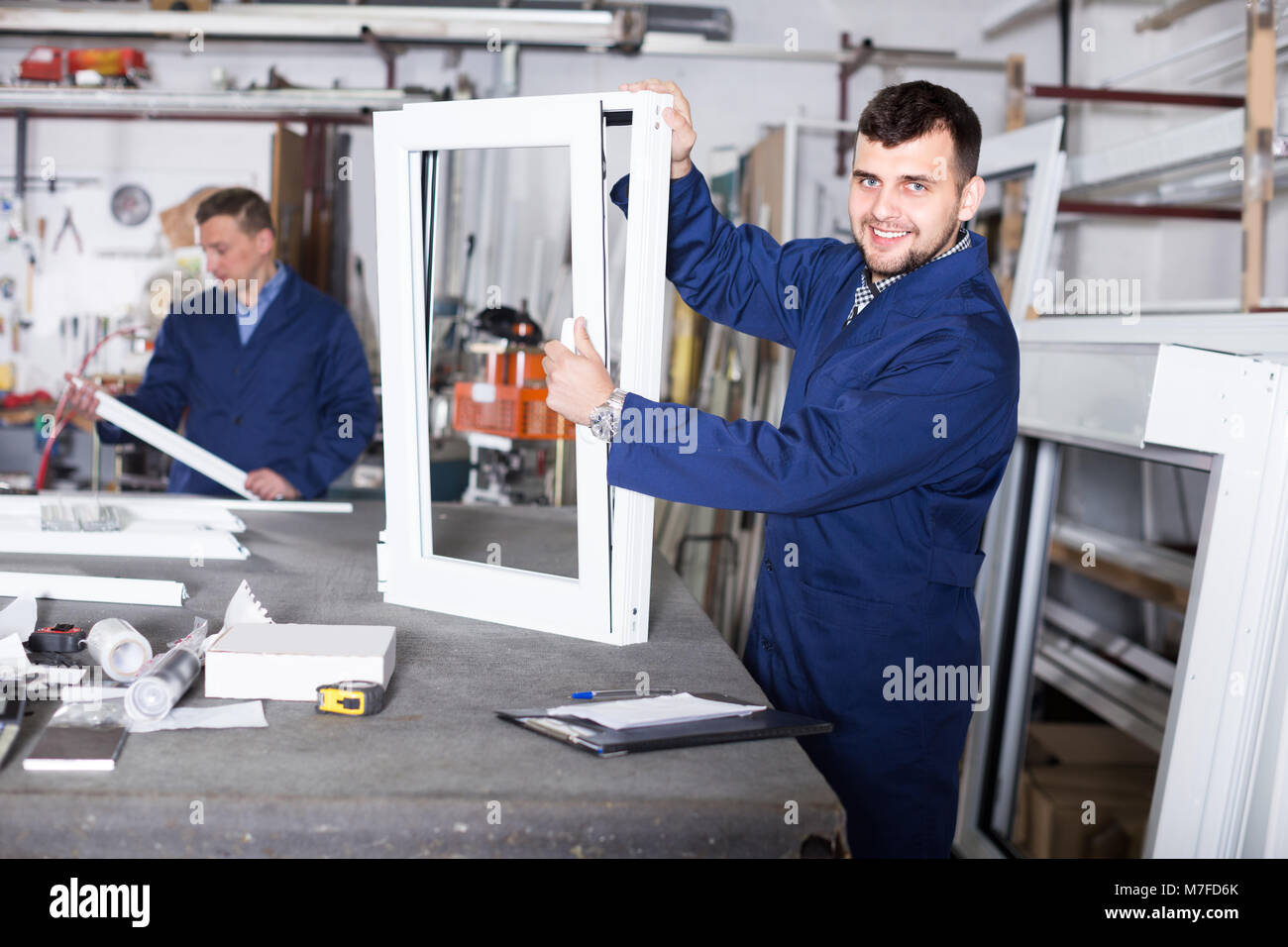 Young engineer is taking order from customer at factory Stock Photo - Alamy