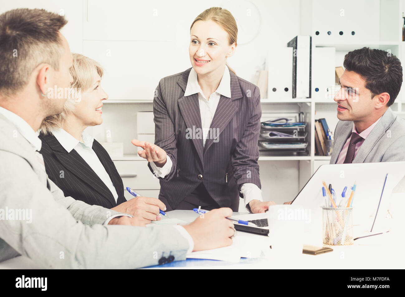 Successful smiling business woman explaining business strategy to ...