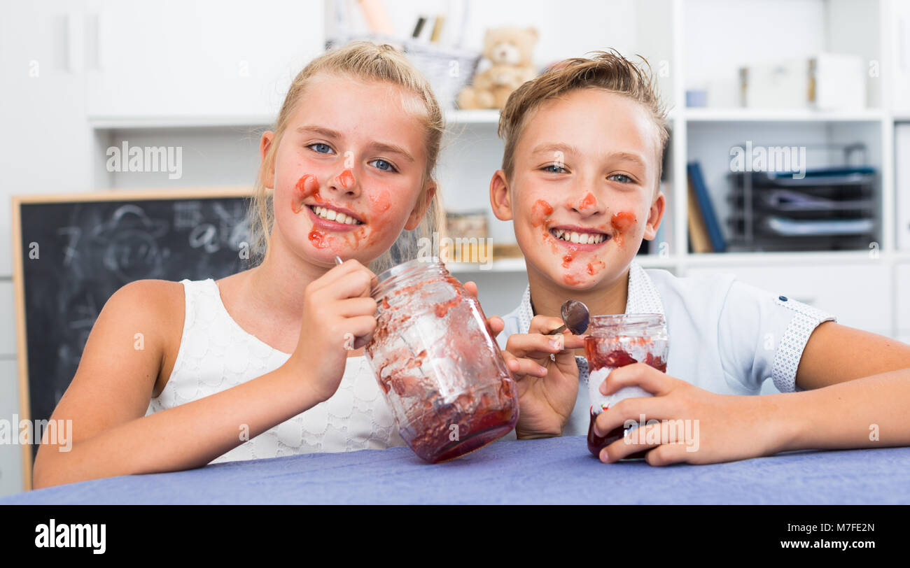 Girl and boy are eating jam at lunch time Stock Photo - Alamy