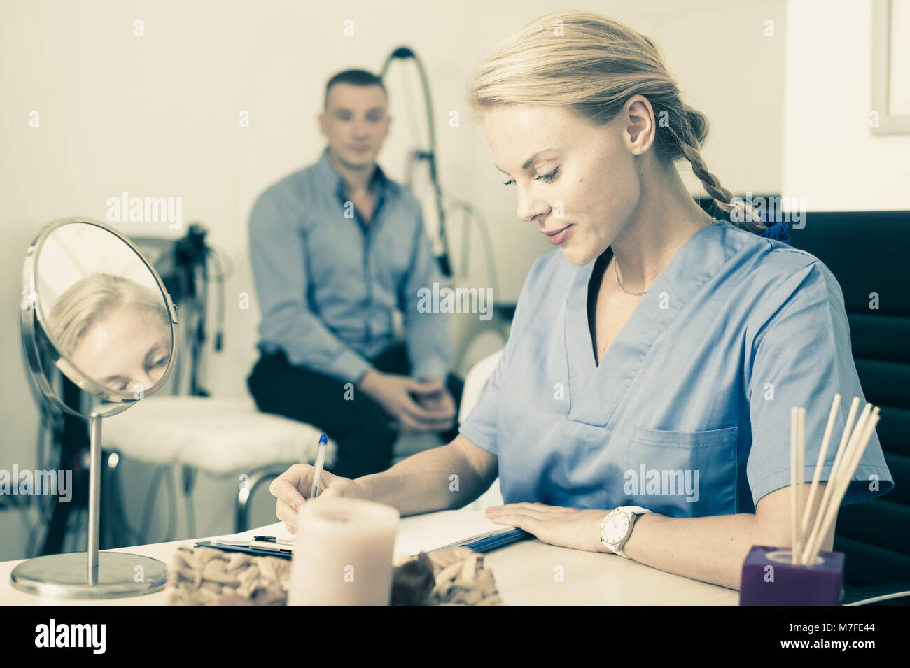 Female doctor is writing the conclusion about result of examination of ...