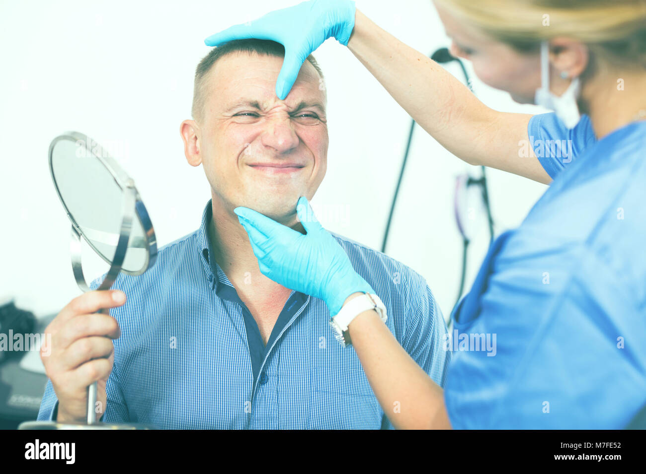 Female doctor is preparing client to procedure in cabinet Stock Photo ...