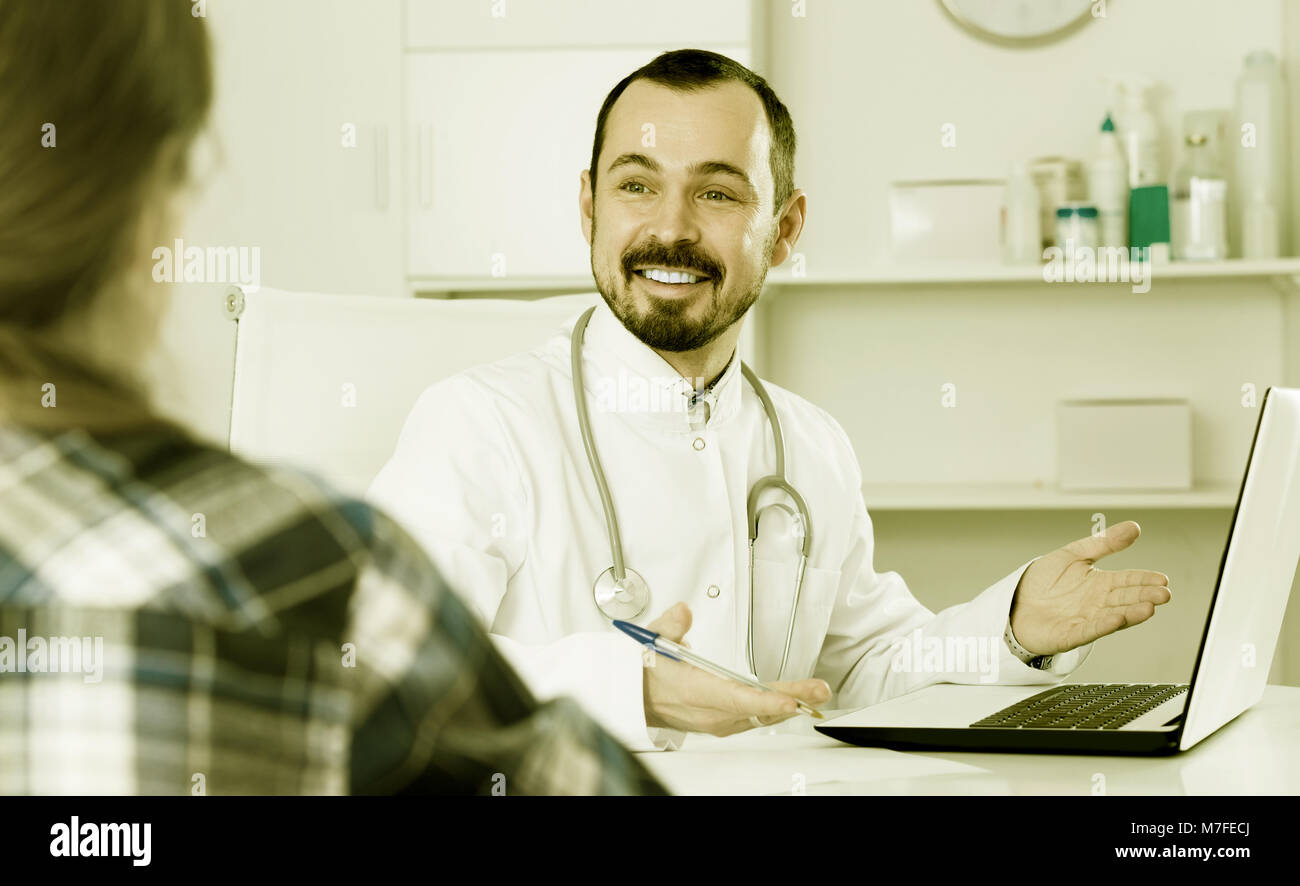 Positive man doctor consultation female client in hospital Stock Photo ...