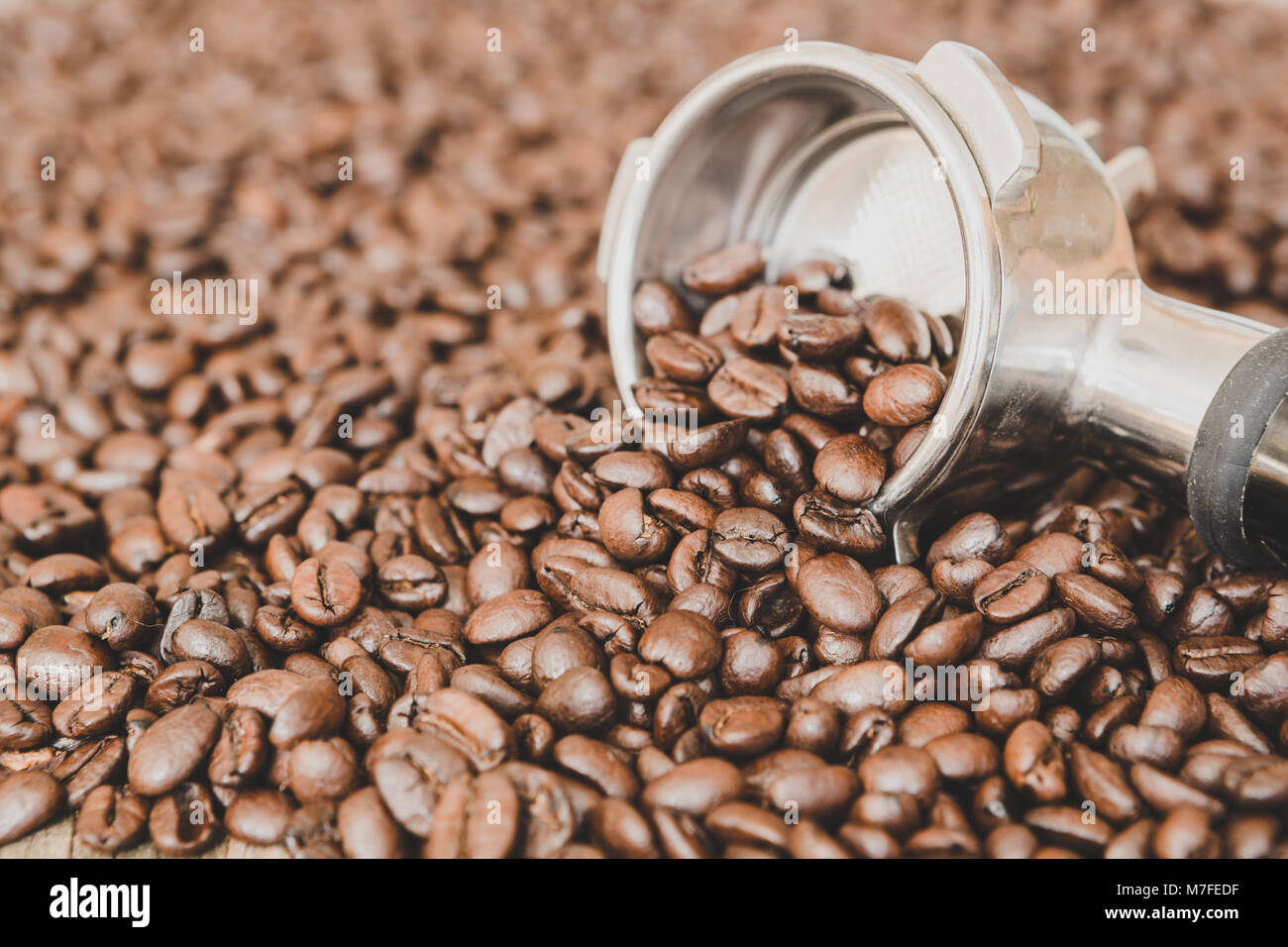 Metal espresso machine scoop on roasted coffee beans background Stock ...