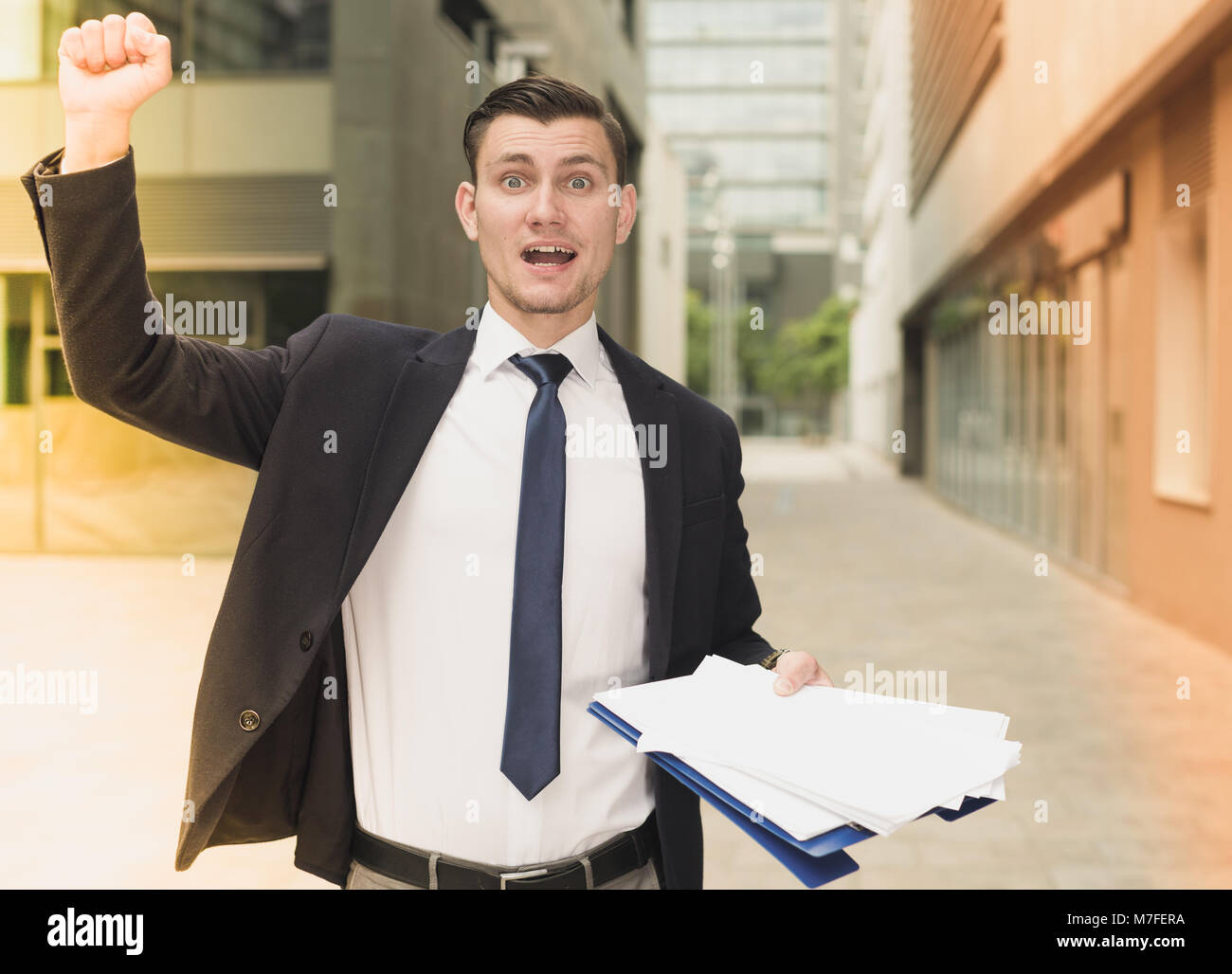 Smiling employee is happy after successful signing contract outdoors ...