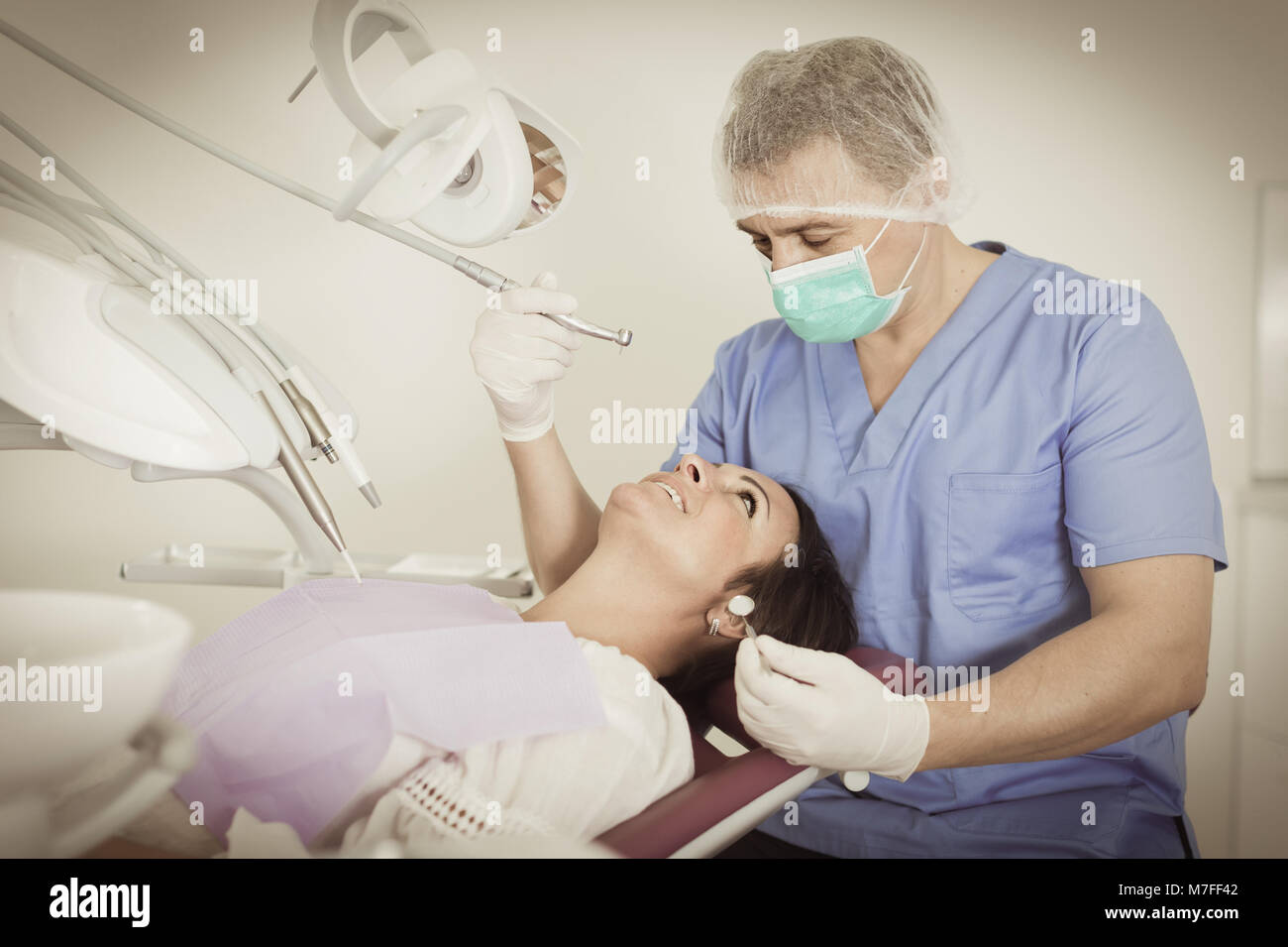 dentist professional filling teeth woman patient sitting in medical chair Stock Photo - Alamy