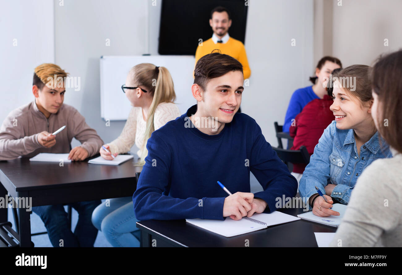 Diligent glad fellow students having group work tasks during school day ...