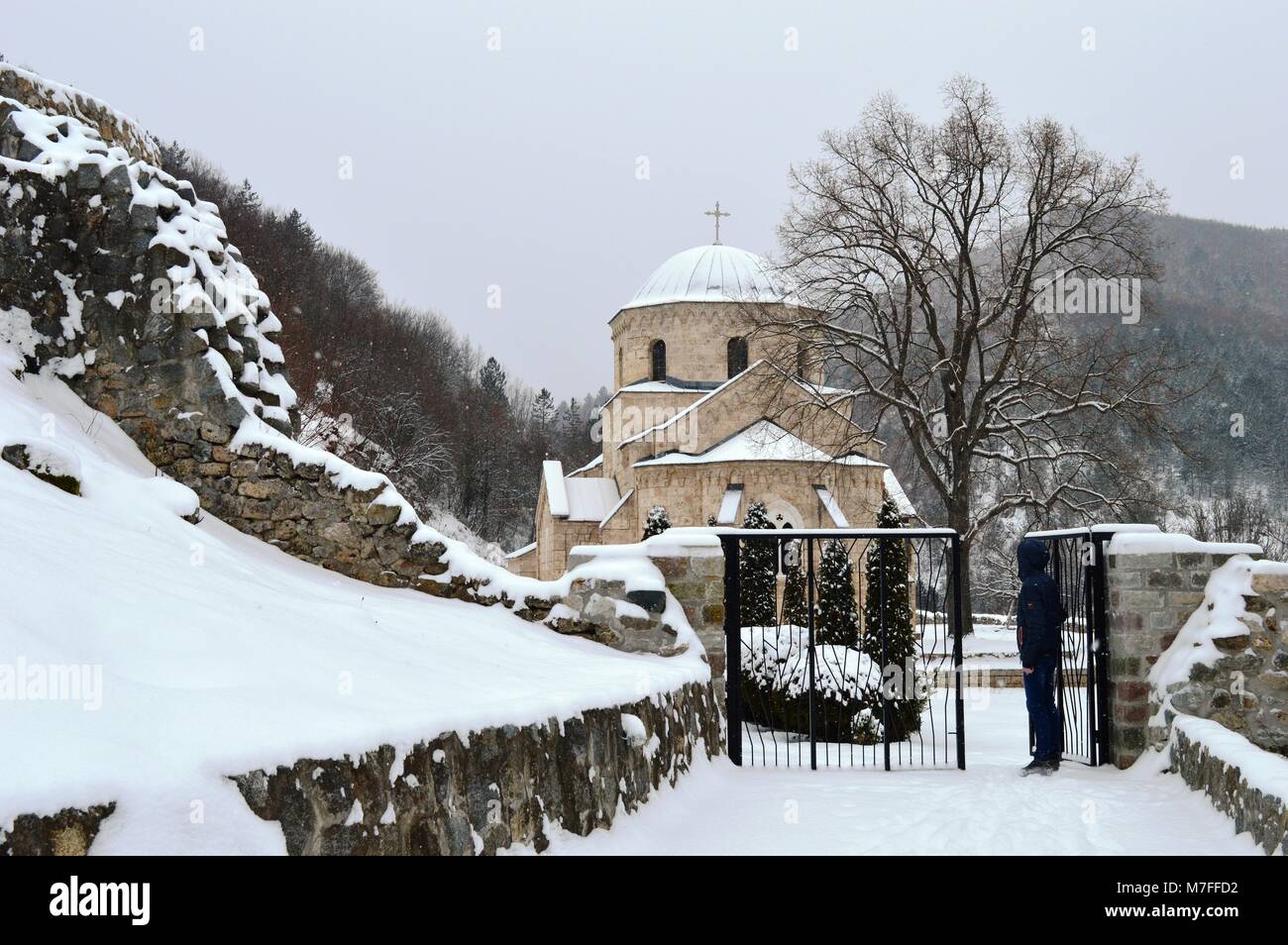 a man at the gate of the monastery Stock Photo - Alamy