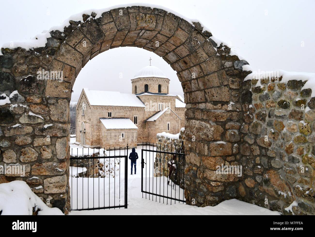 a man at the gate of the monastery Stock Photo - Alamy