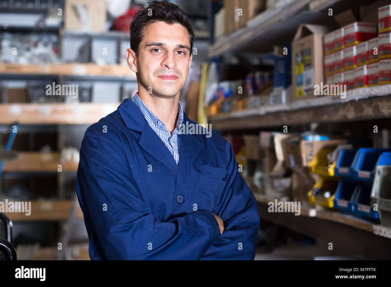 Portrait of friendly working male in uniform on his workplace in ...