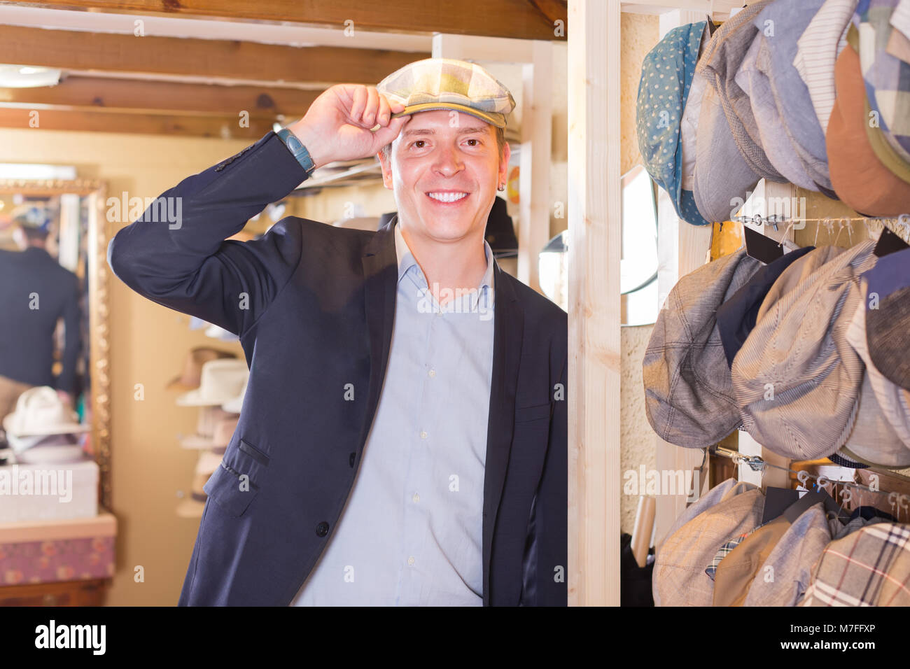 portrait of male try on flat hat from the range at the shopping mall ...