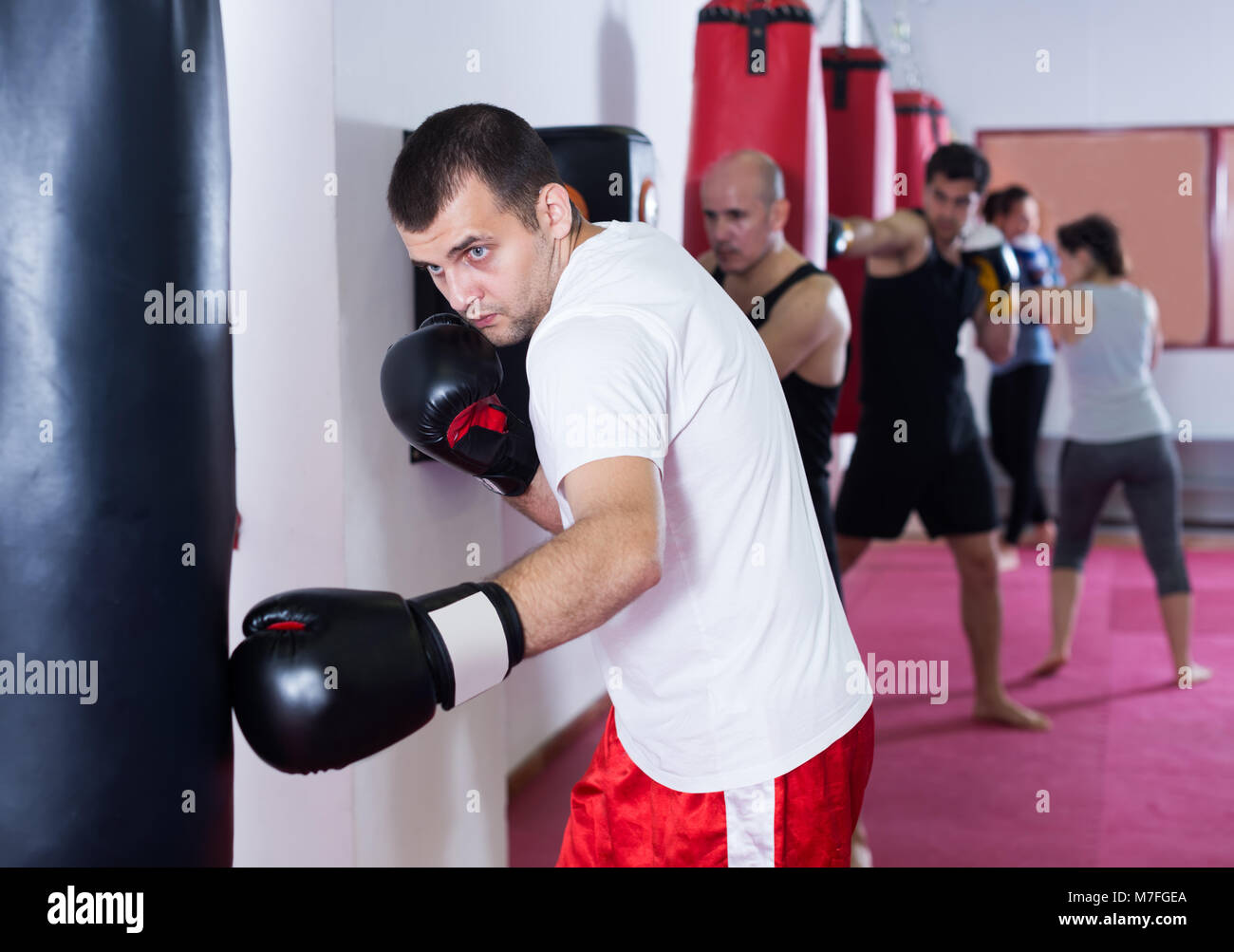 male beating boxing bag exercise in boxing gloves Stock Photo - Alamy