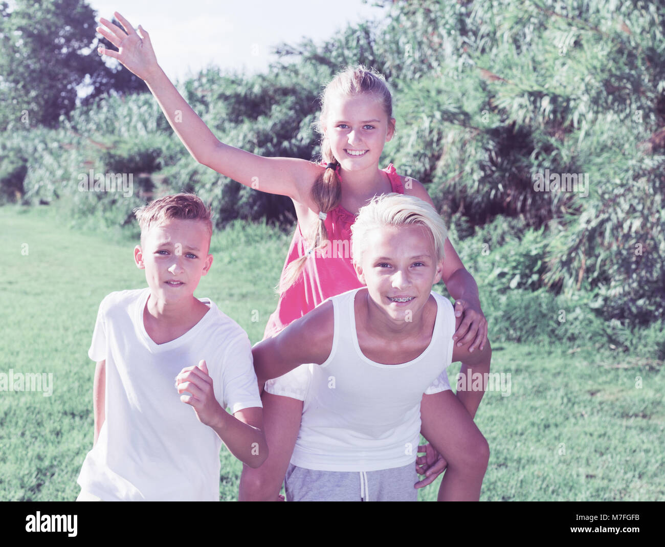 Group of laughing kids running happily together on grass Stock Photo ...
