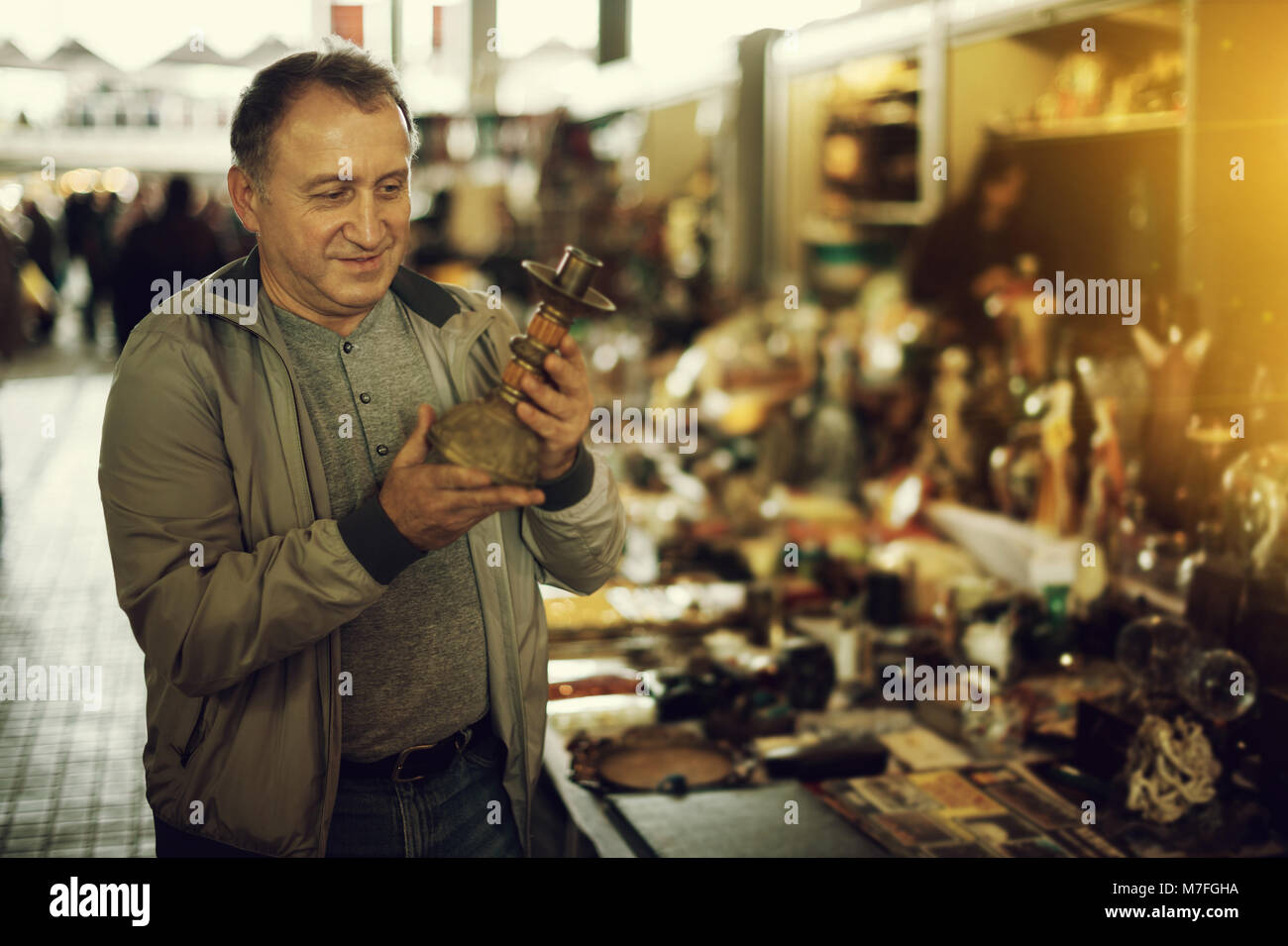 Male is visiting open air market of old things and shopping outdoors ...