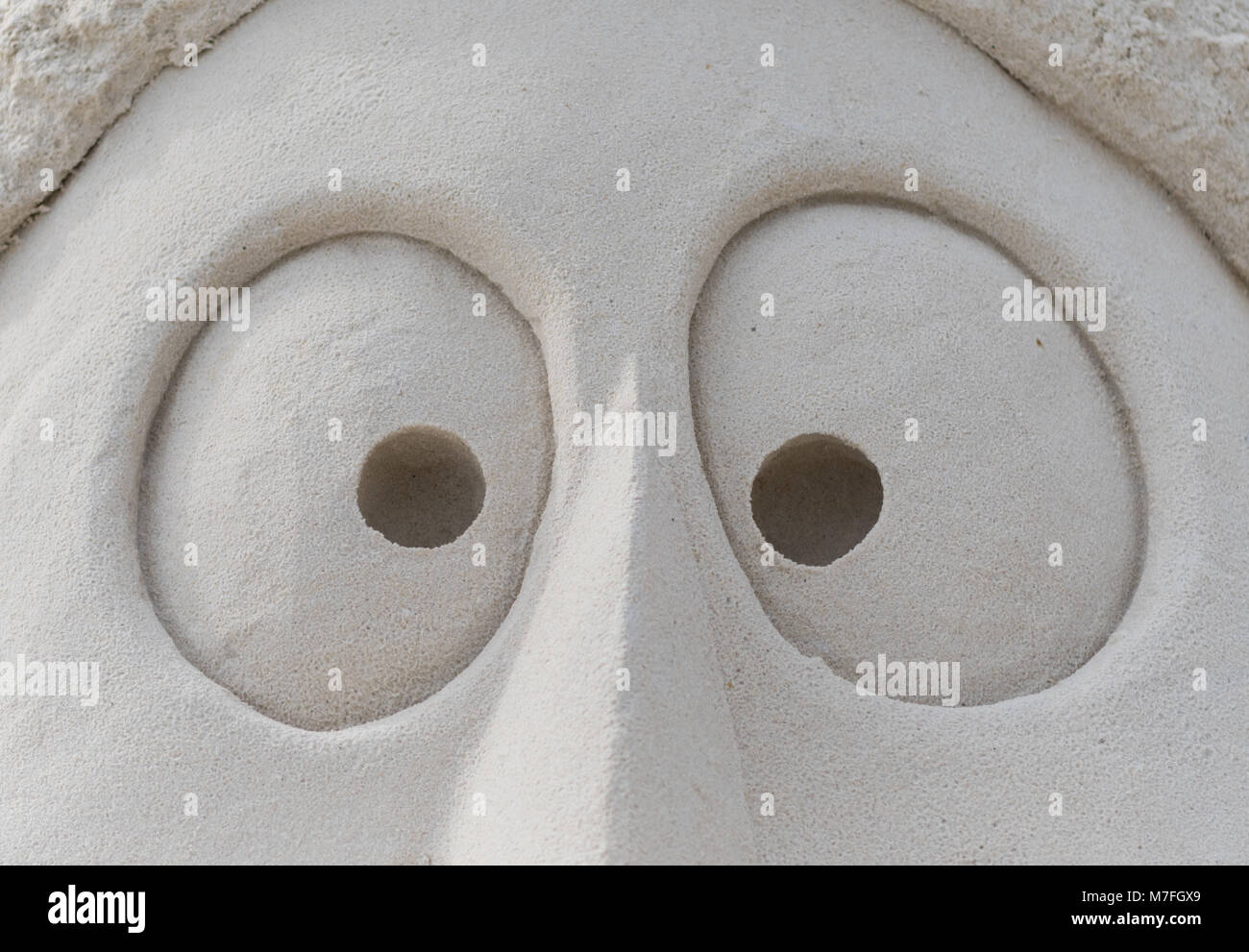 Eyes in Sand on face sand sculpture close up Stock Photo - Alamy
