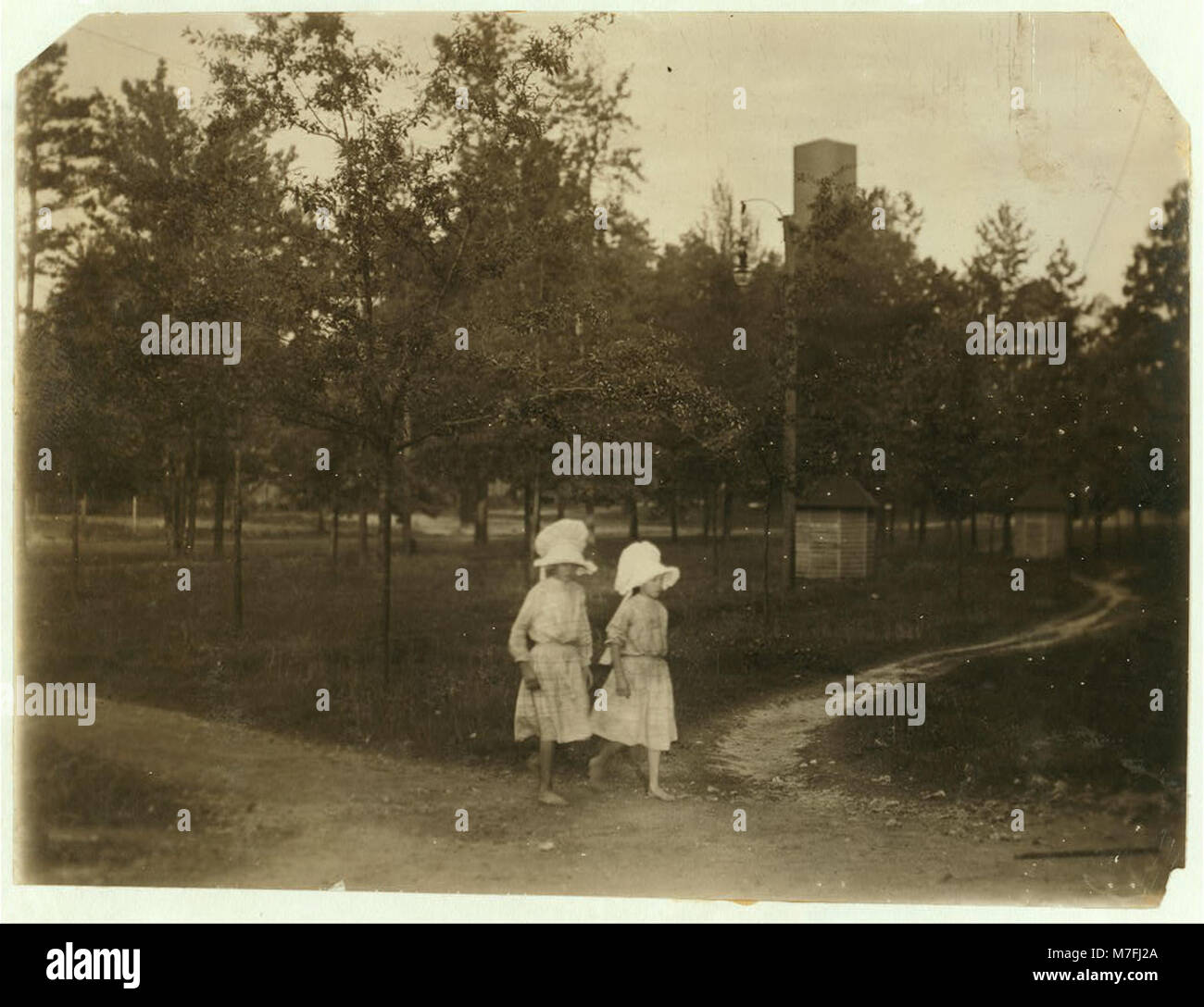 The photograph depicts the Wilson twins, dressed for work, possibly in ...