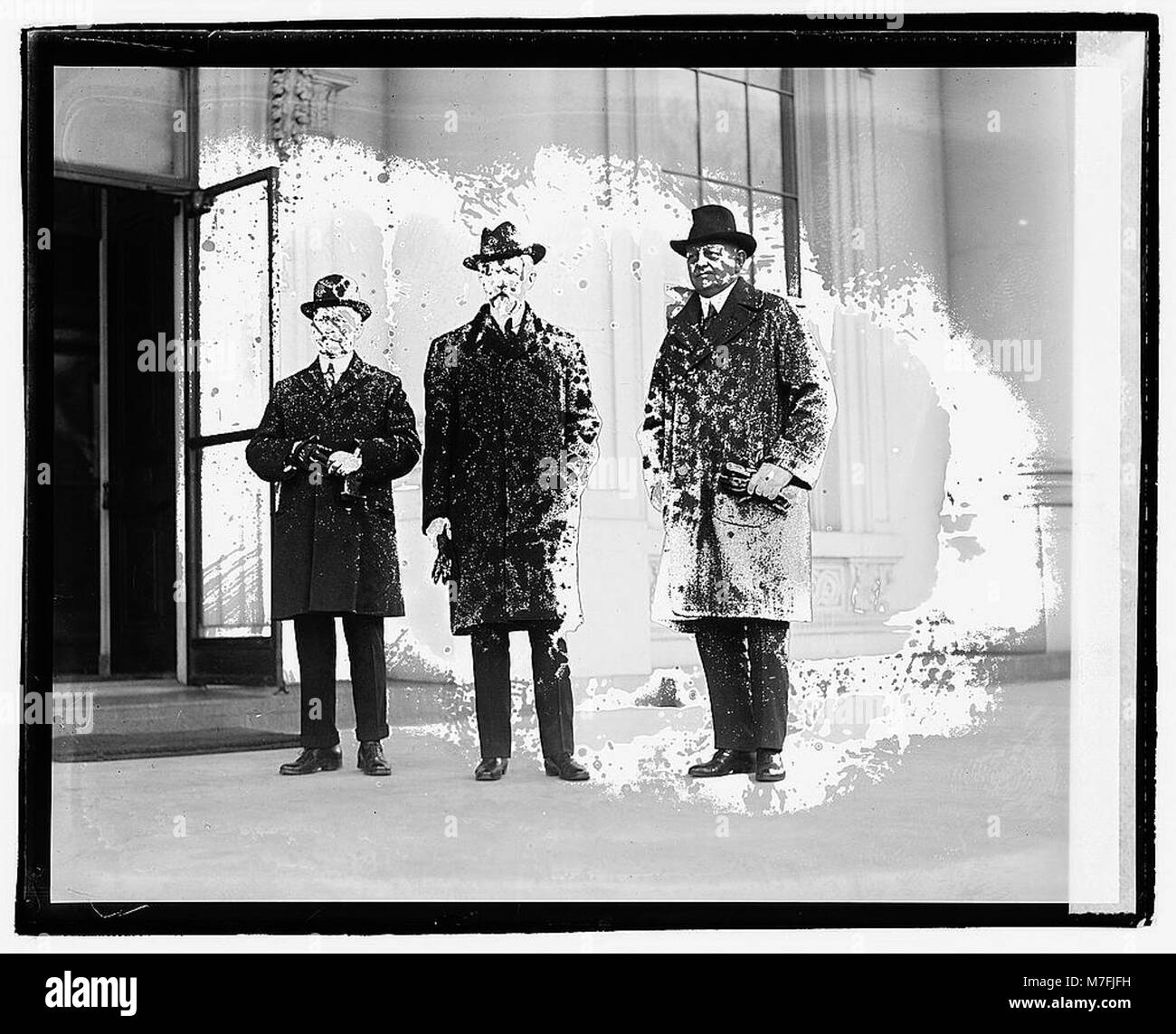 A photograph of three men standing outside a building on December 6 ...
