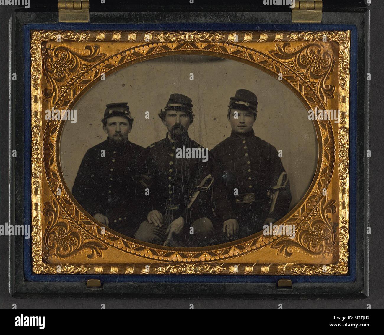 Three soldiers in Union Army uniforms from the Civil War are pictured ...