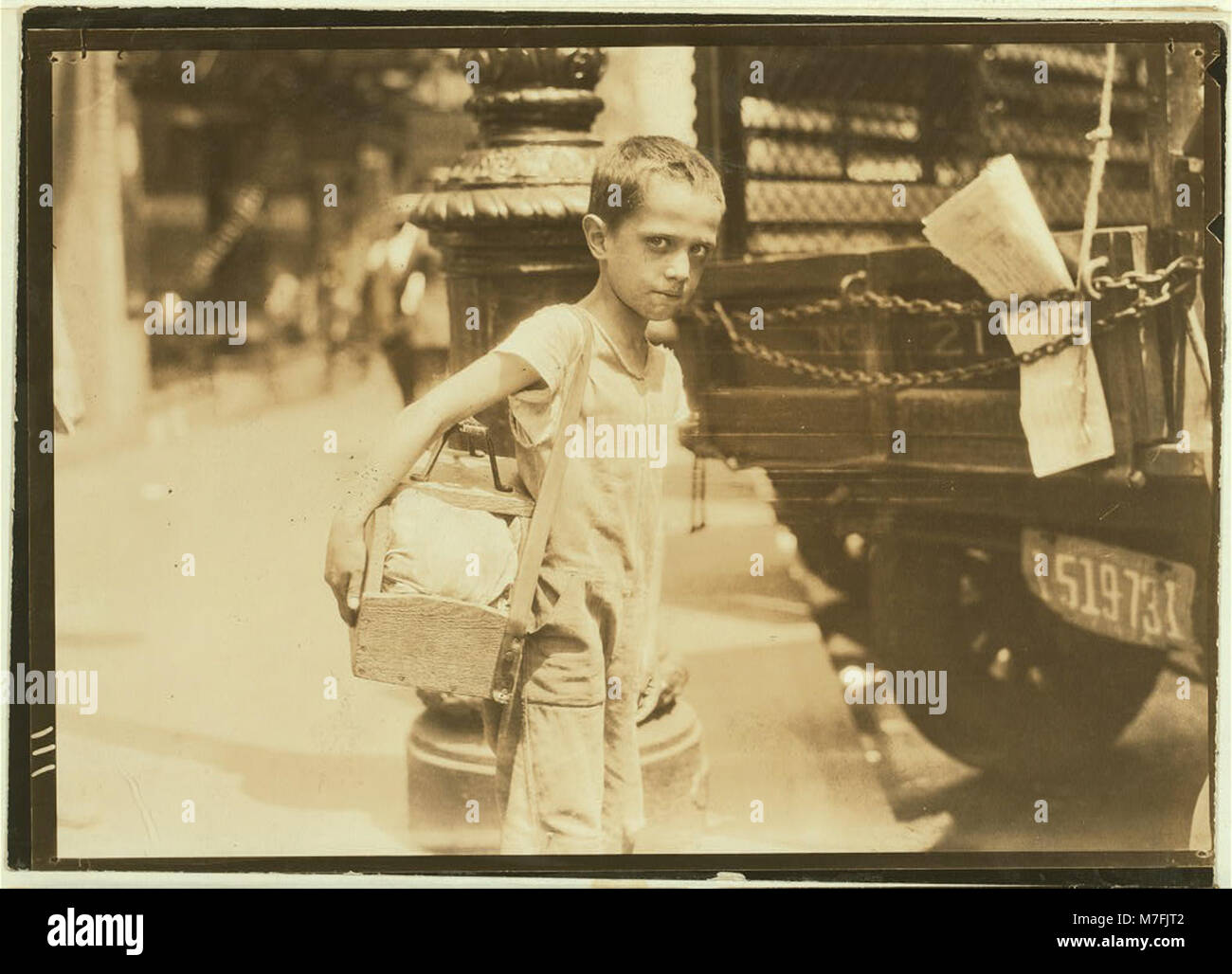 This photograph captures Tommie, a young shiner working on Canal Street ...
