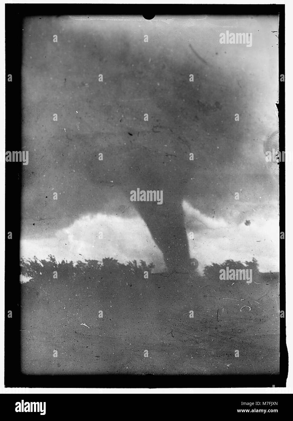 A dramatic photograph of a tornado, capturing the intense force and ...
