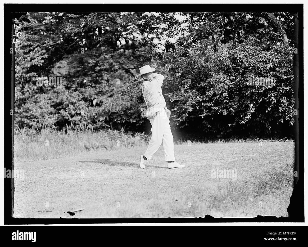 A portrait of Walter Travis, a renowned golfer, captured in action ...