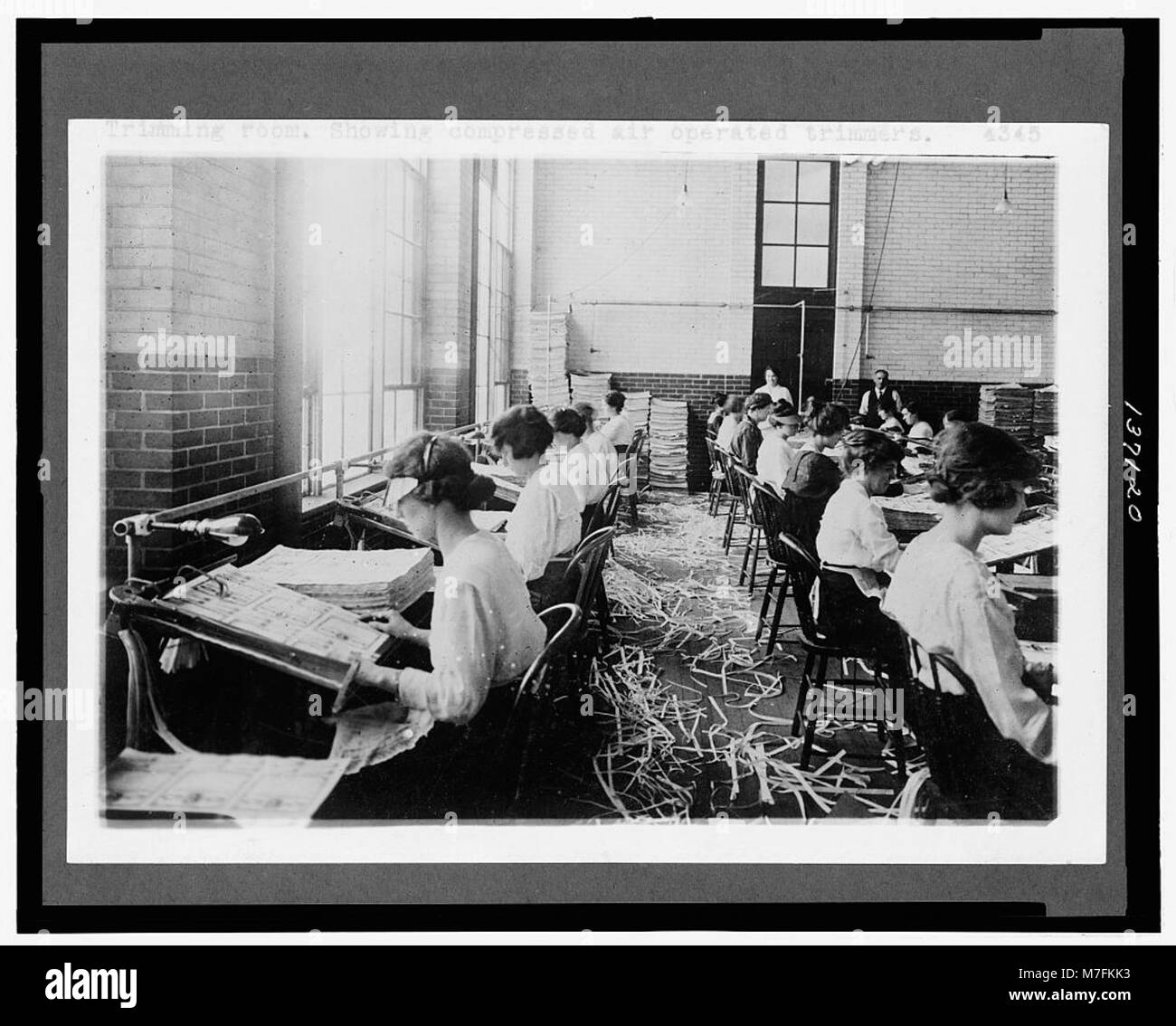 This image shows a trimming room where compressed air-operated trimmers ...