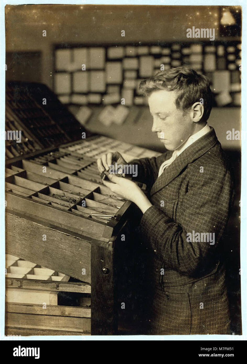An image depicting the process of typesetting, showcasing the manual ...