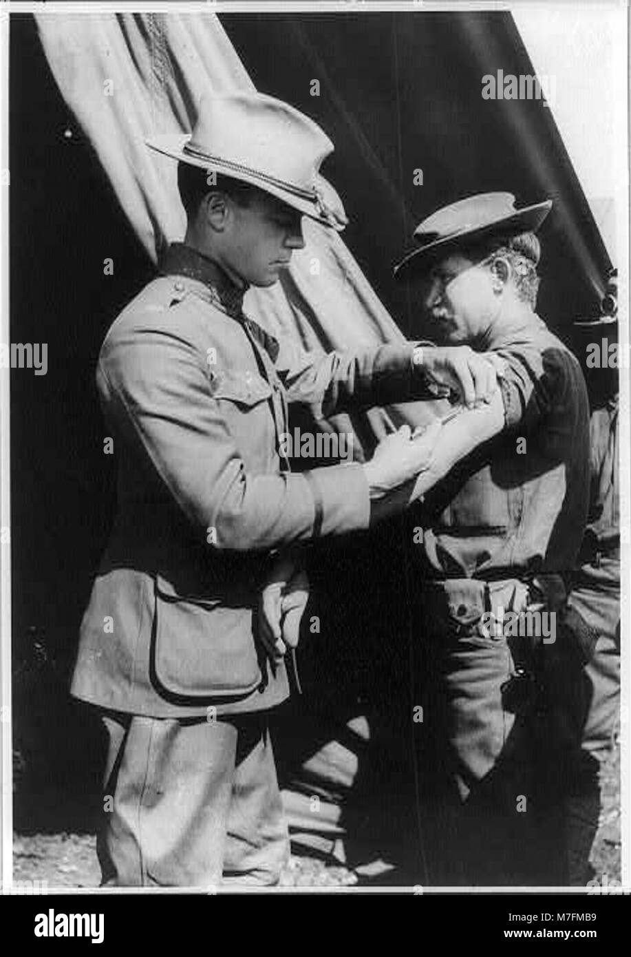 U.S. Army medical officer vaccinating soldier with arm injection, San ...