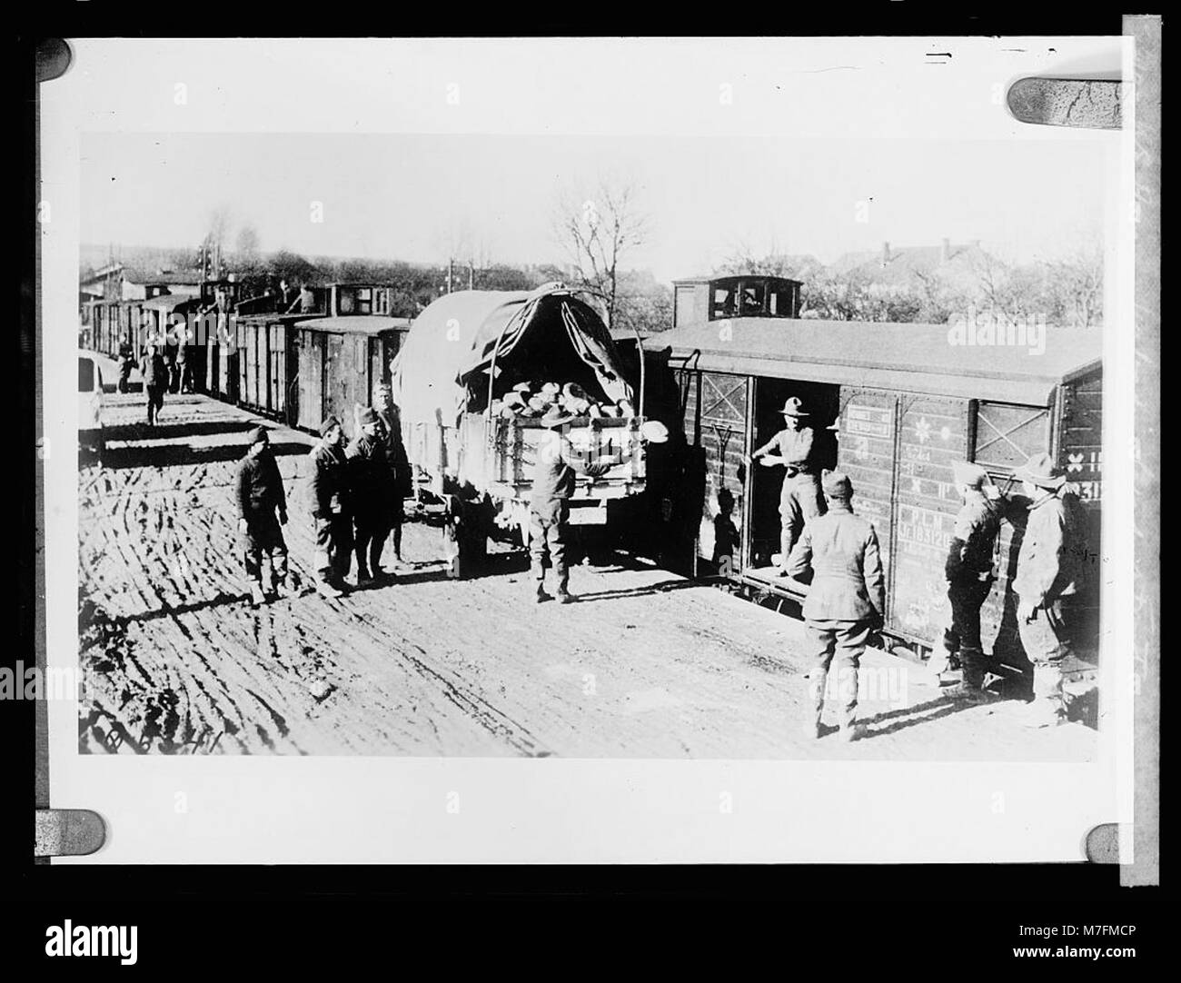 A photograph showing U.S. Army personnel unloading bread supplies at ...