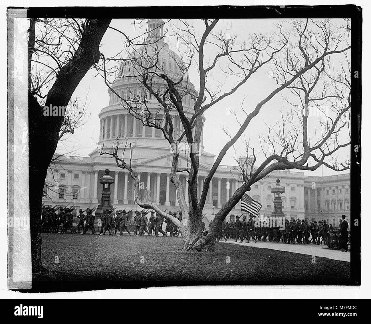An image depicting the U.S. Capitol with the 63rd Infantry, reflecting ...