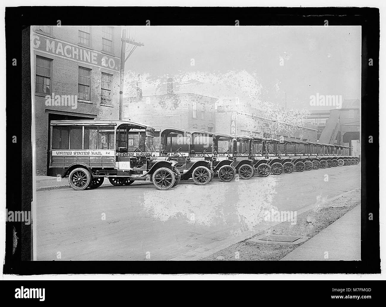 A historical photograph of U.S. Mail trucks in operation, showing the ...