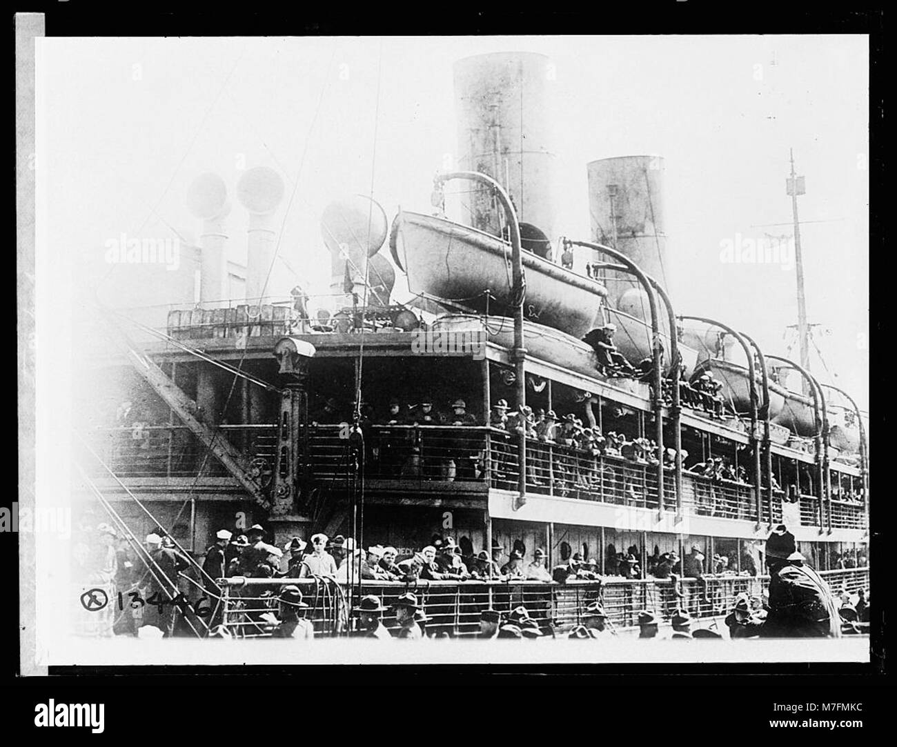The image depicts U.S. troops aboard a transport ship, possibly during ...