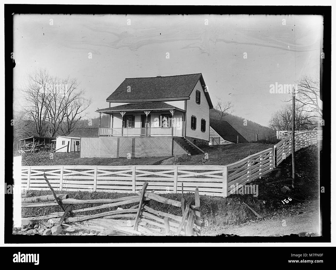 A photograph or document depicting an unidentified farmhouse ...