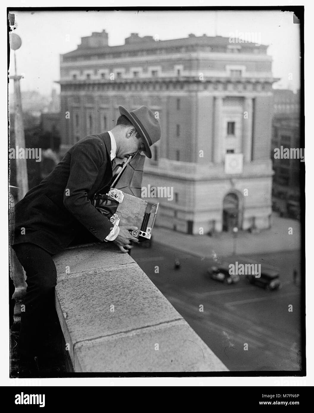 A photograph showing an unidentified photographer with a camera ...