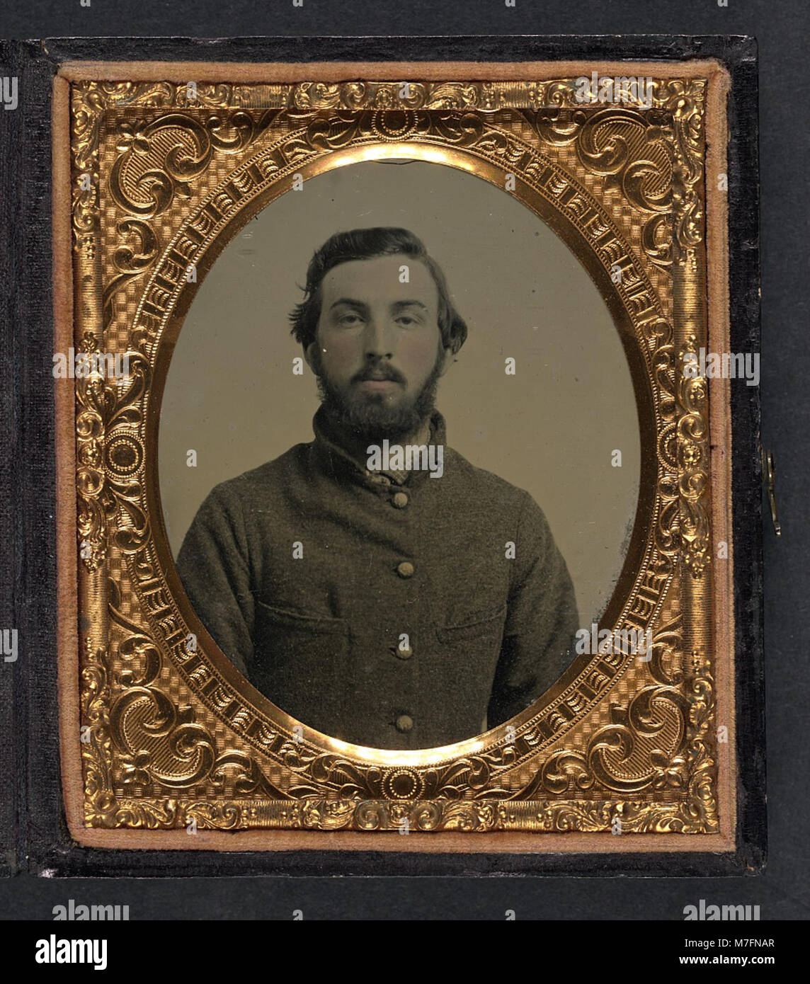A historical photograph showing an unidentified soldier wearing a ...