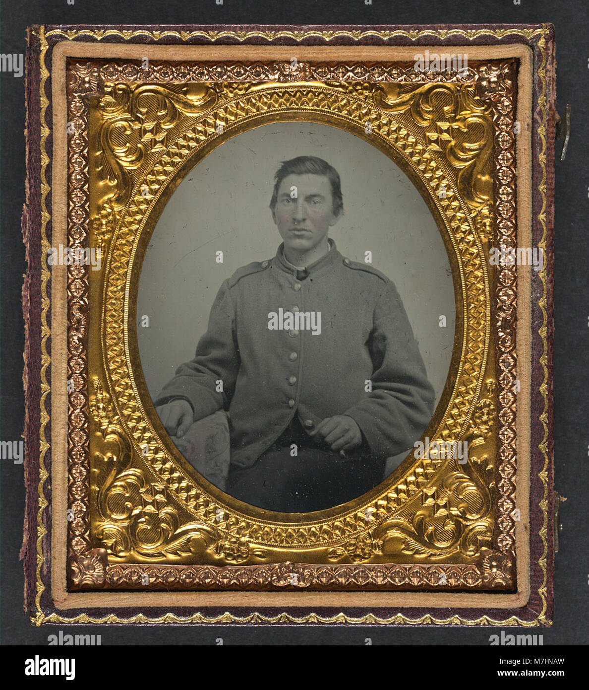 An unidentified soldier wearing a Confederate shell jacket with ...
