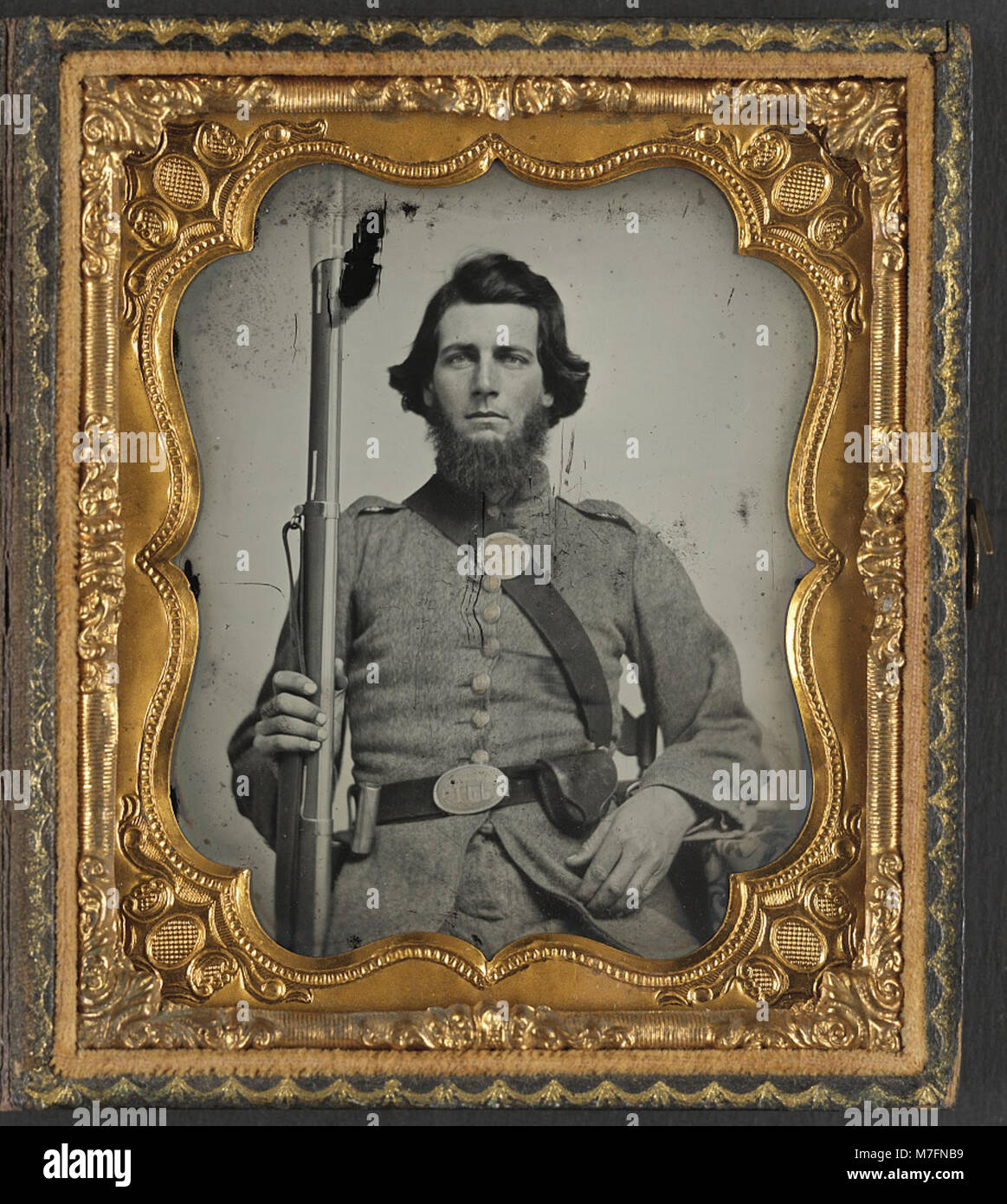 An unidentified Confederate soldier dressed in uniform, wearing a ...